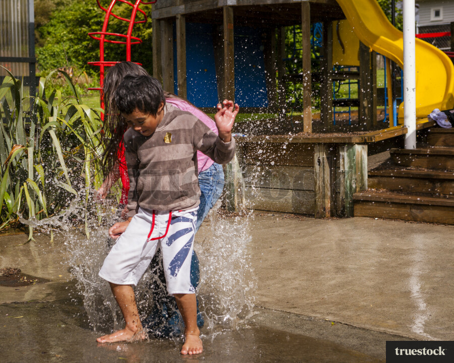 Young Kids Playing with Water at School by Spid Pye - Truestock