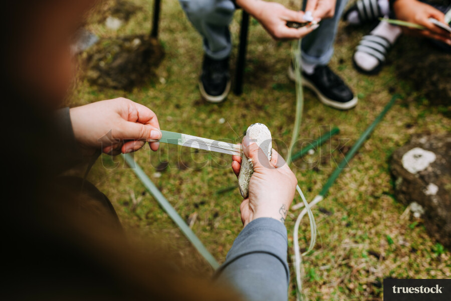 Moari culture weaving ropes by Erica Sinclair - Truestock