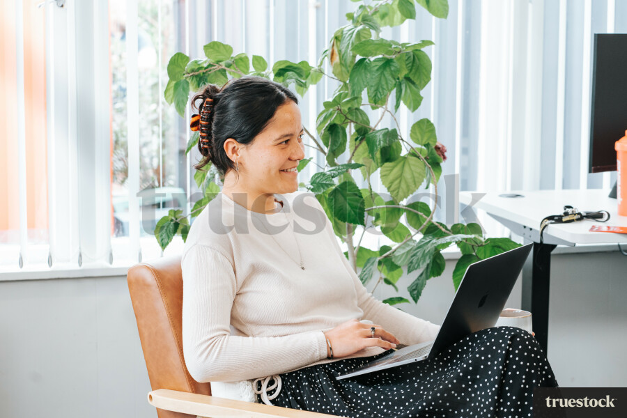 Woman Using Laptop at Work by Ngahuia Ormsby - Truestock