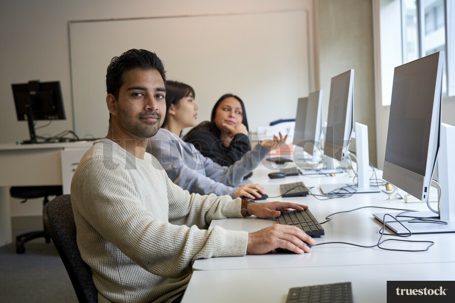Students Using Computer at University by Spid Pye - Truestock