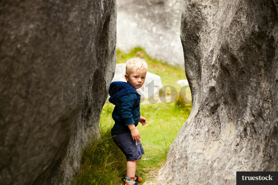Child exploring the ancient rocks weathered limestone in the ...