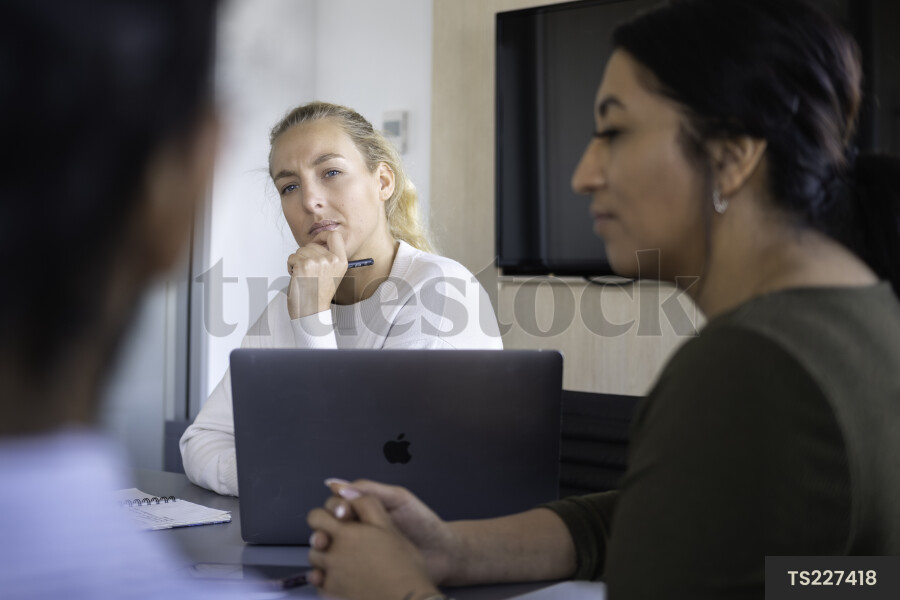 Colleagues in Meeting by Keith Molloy - Truestock