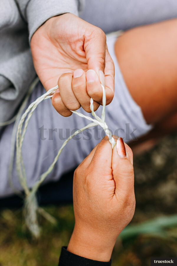 Moari culture weaving ropes by Erica Sinclair - Truestock