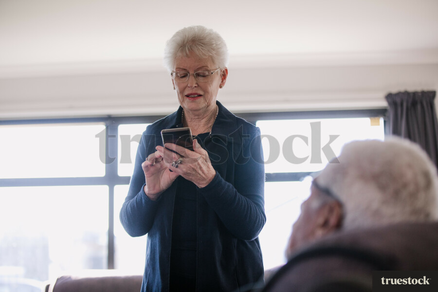 Elderly Woman on her Smartphone by Kathryn Taylor - Truestock