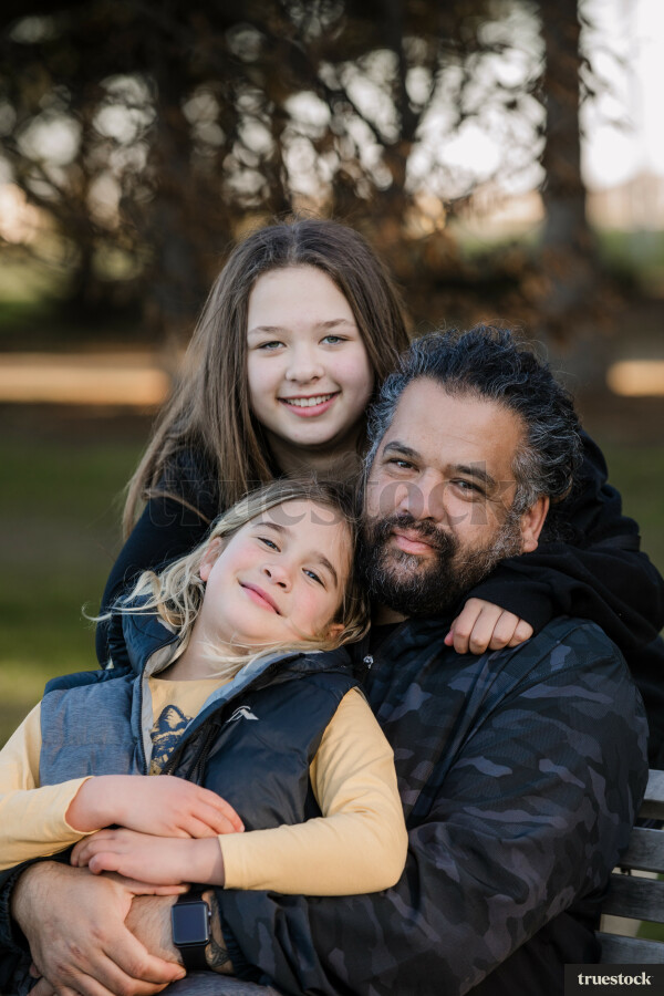 Dad With His Daughters At The Park By Kathryn Taylor Truestock