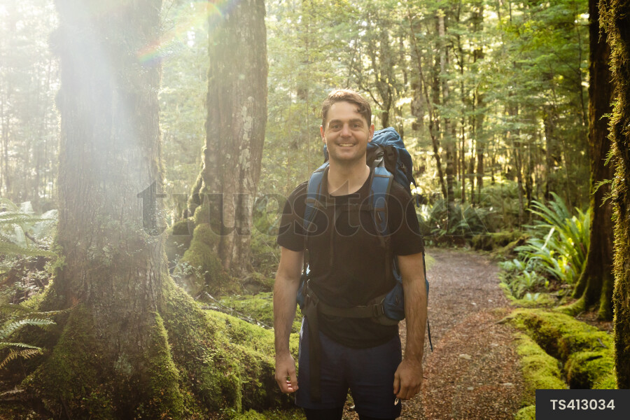 Man hiking in forest by Danny Rood - Truestock