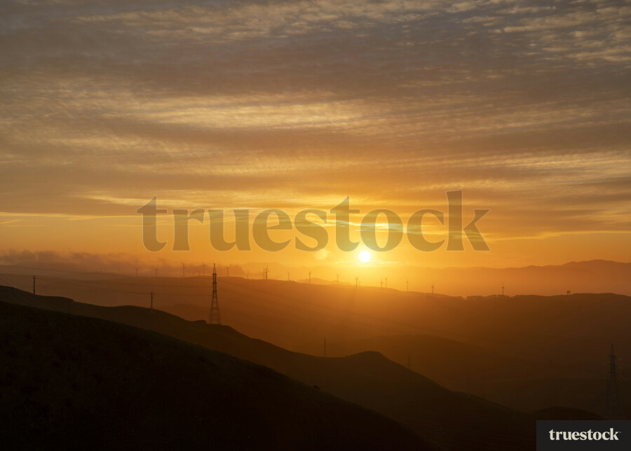 Wind turbines at sunrise by James Stonley - Truestock