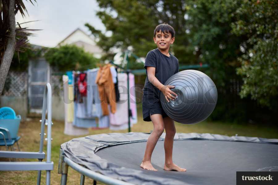 Boy Playing Outside in Backyard by Josh Griggs - Truestock