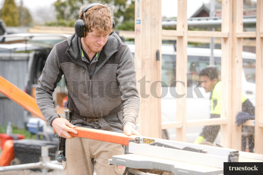 Builder onsite working on a new suburban house build by Kathryn Taylor ...