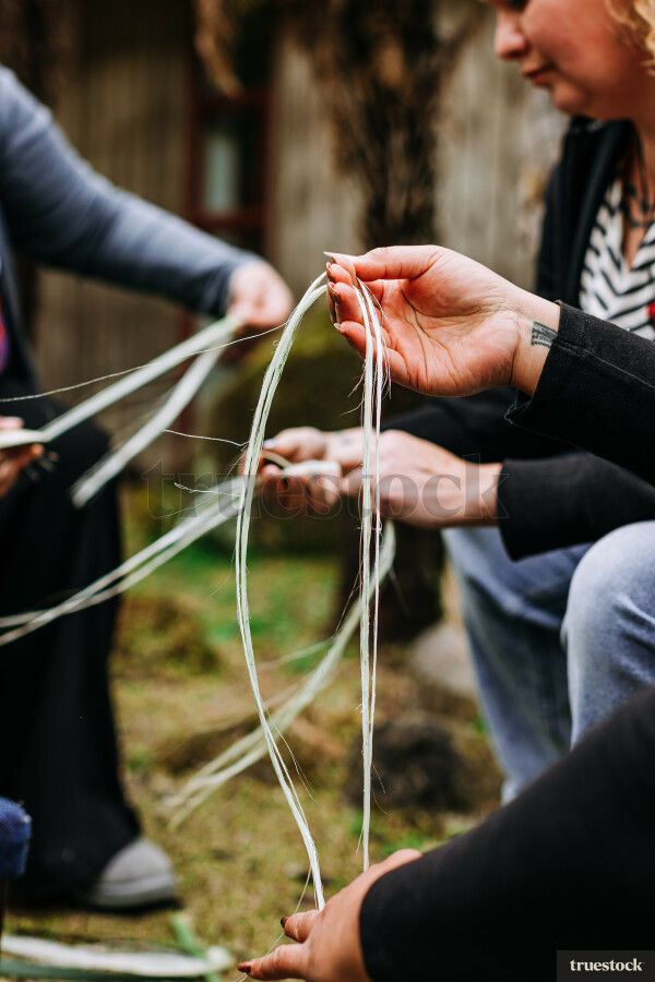 Moari culture weaving ropes by Erica Sinclair - Truestock