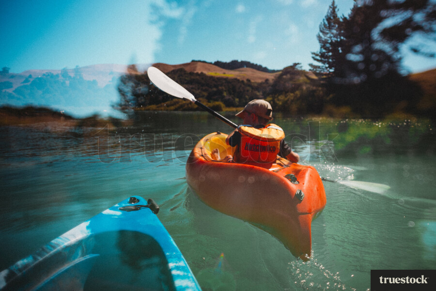 Young Boy Kayaking by Chloe Lodge - Truestock