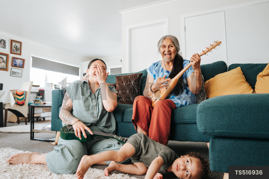 Family with Ukulele in Lounge by Ngahuia Ormsby - Truestock