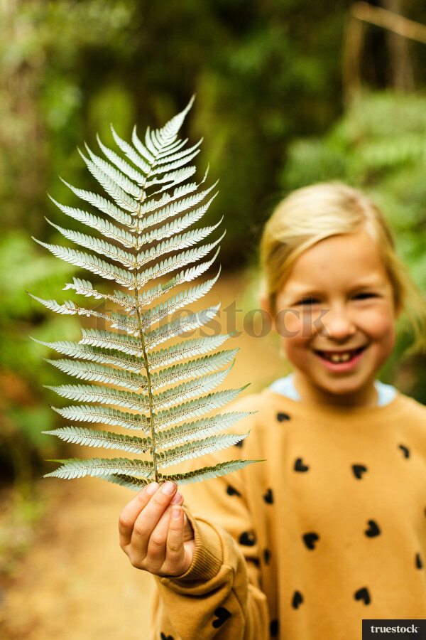 Young Girl Holding Fern by David Marano - Truestock