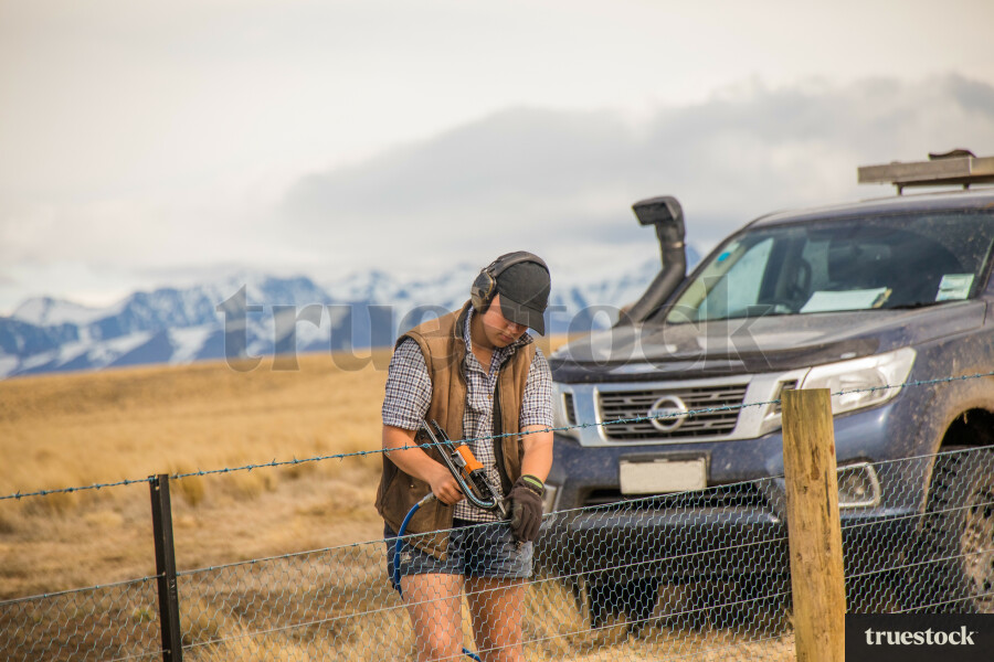 Fencer Working on Fence by Bev Bell - Truestock