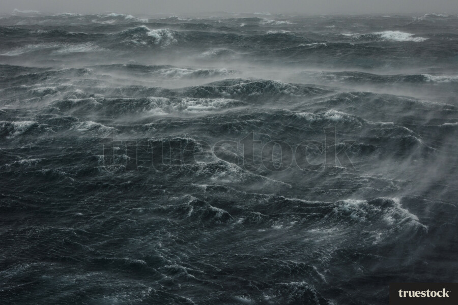 Rising tide levels from wild storm in the ocean by Danny Rood - Truestock