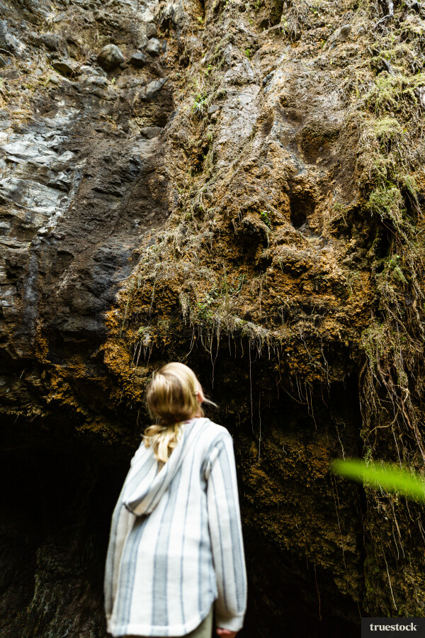 Young Girl Lookking at Rock Cave by David Marano - Truestock