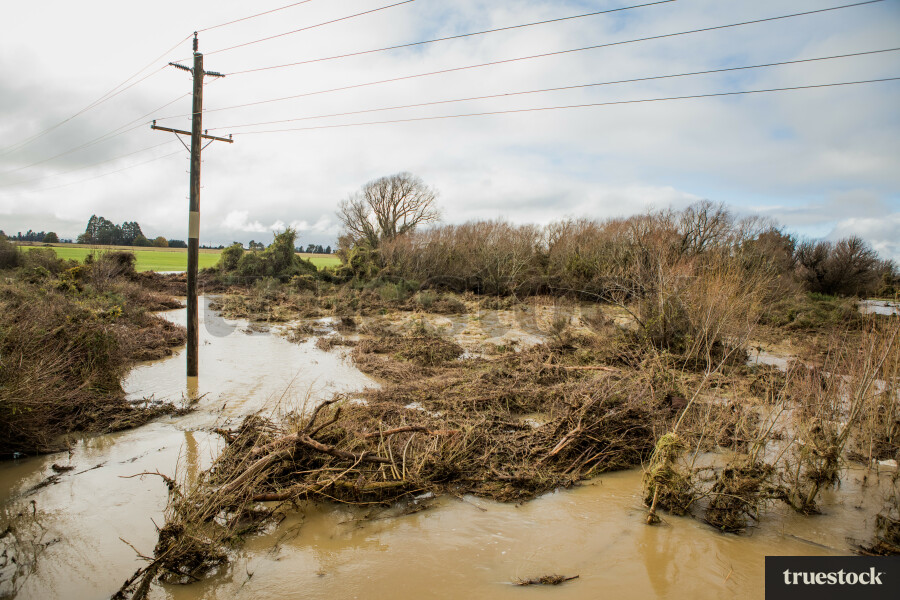 Rising river water and debris from flooding by Kathryn Taylor - Truestock