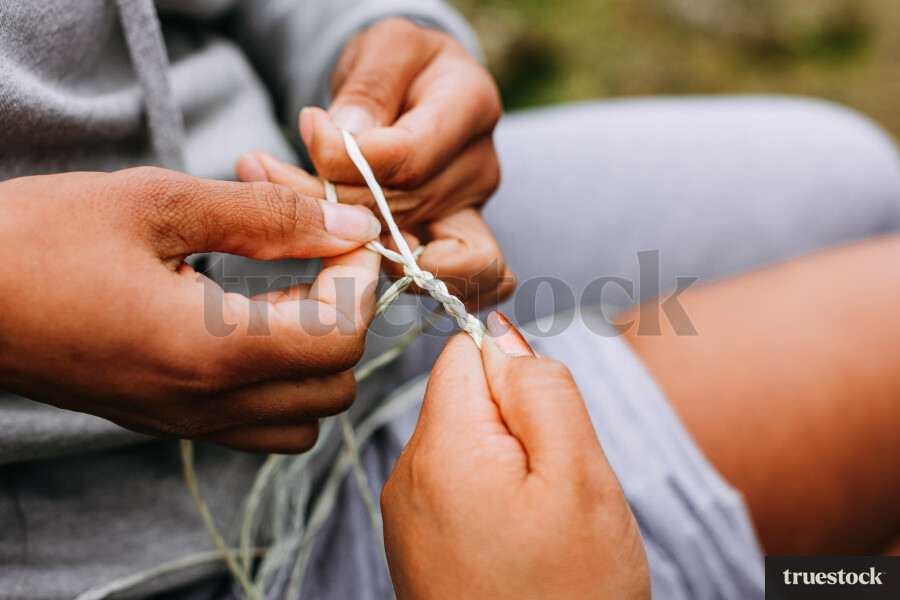 Moari culture weaving ropes by Erica Sinclair - Truestock