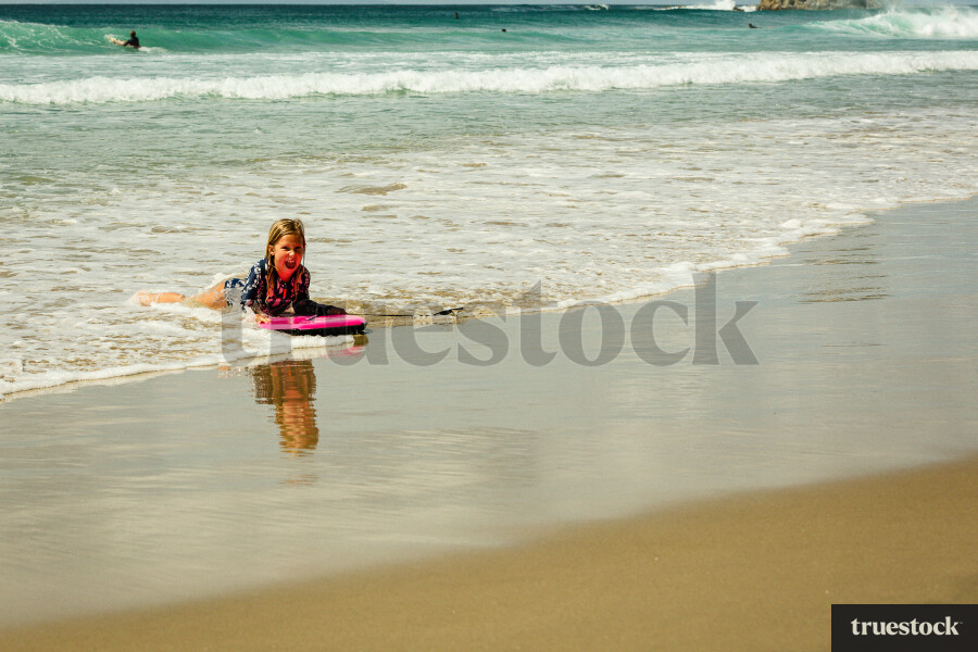 Child Playing in the Ocean by David Marano - Truestock