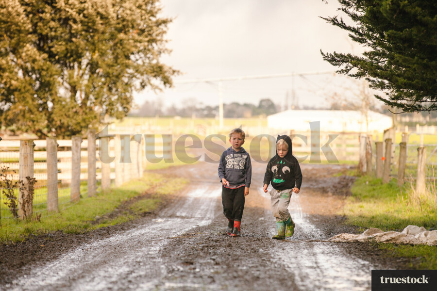 Children on a farm running by Kathryn Taylor - Truestock