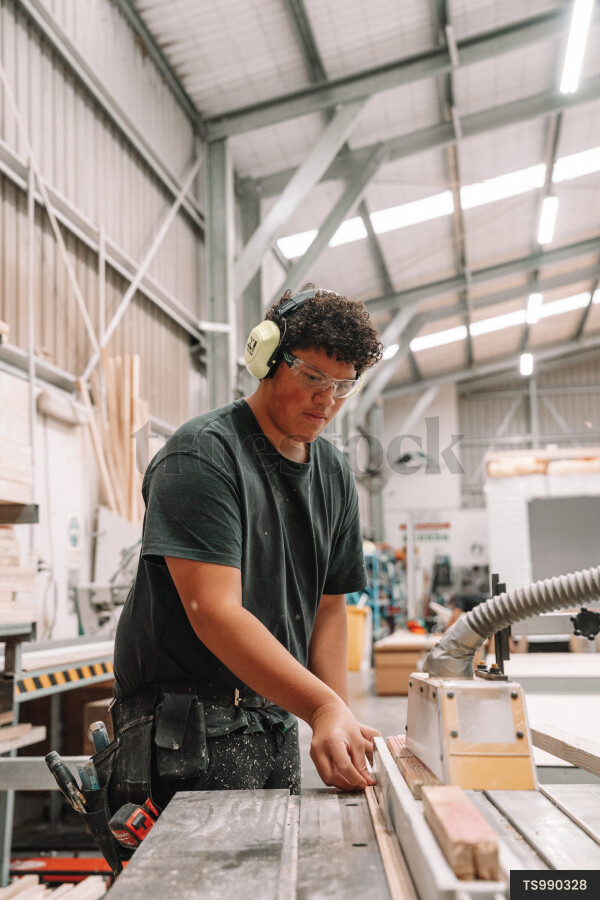 Worker Using Machinery by Ngahuia Ormsby - Truestock